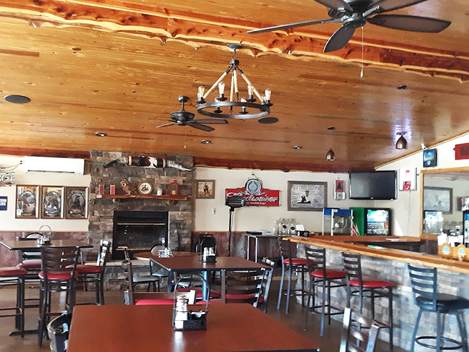 The stone fireplace and wood-paneled ceiling create a rustic elegance that says, "We're serious about comfort and serious about food."