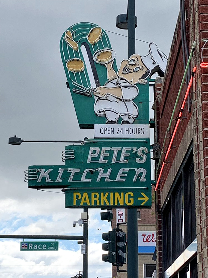 That vintage neon chef, eternally flipping pancakes in the sky, has watched over Colfax Avenue's parade of humanity for generations.