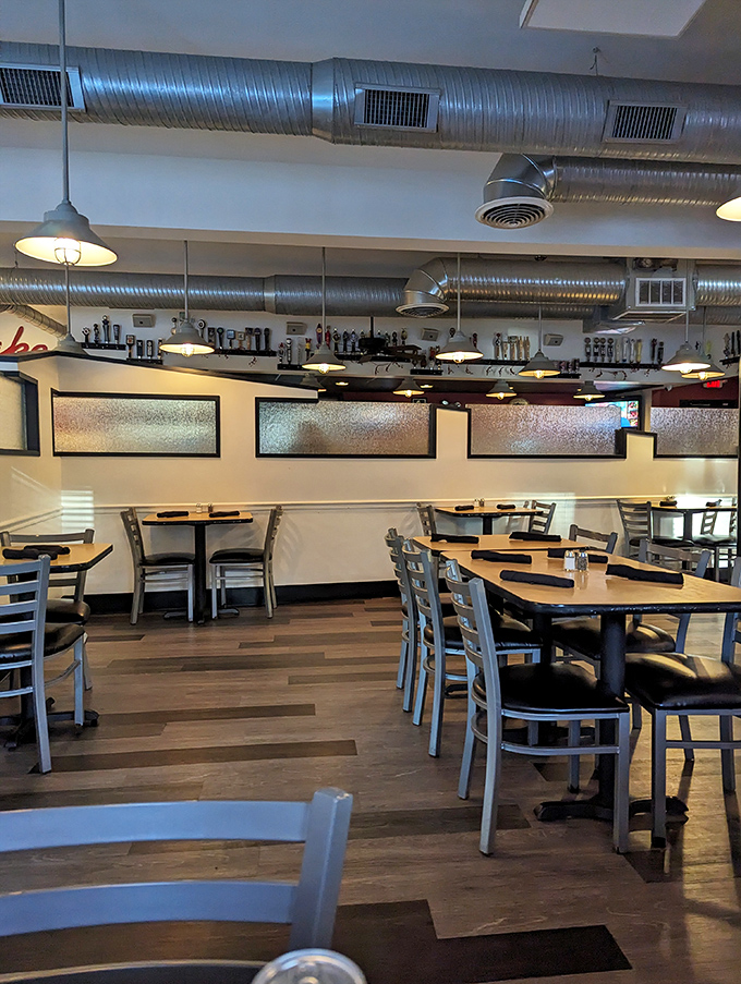 Industrial-chic meets comfort in this dining area. The exposed ductwork watches over diners like a benevolent metal guardian.