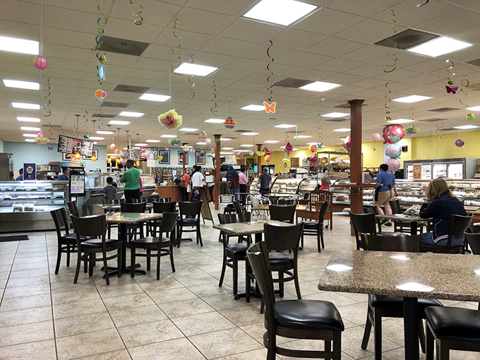 The dining area hums with conversation and satisfaction. Colorful decorations overhead add festive charm to this community gathering spot.