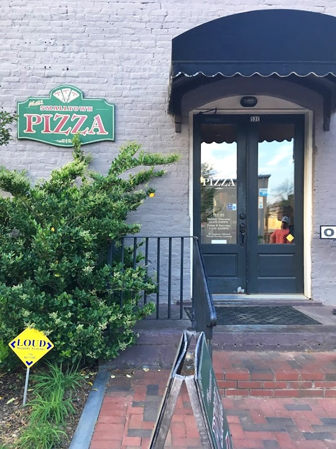 The entrance that's welcomed countless hungry souls. That simple green sign and black awning might as well say "Pizza Paradise Ahead."