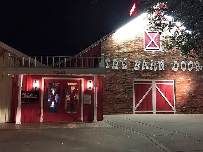 As night falls, those red doors glow with promise&mdash;like a beacon calling you home to dinner, Texas-style.