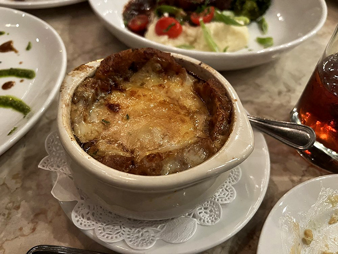 French onion soup that's traveled the culinary equivalent of climbing Everest &ndash; broiled cheese summit included with no extra oxygen required.