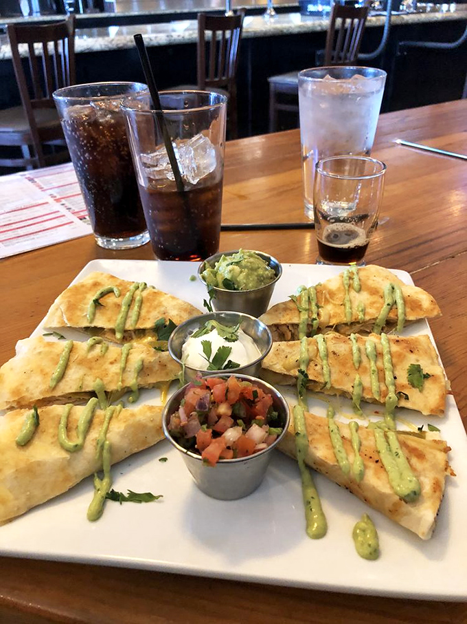 A quesadilla that demands to be photographed before being devoured. Those three dipping sauces aren't just condiments&mdash;they're personality tests.