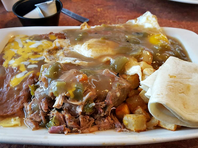 The breakfast of champions: tender shredded pork swimming in green chile sauce with potatoes and eggs joining the party&mdash;a morning fiesta on a plate.