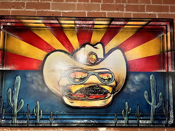 A burger-themed mural sporting sunglasses and a cowboy hat captures Lindy's irreverent spirit. This is Arizona burger culture personified.