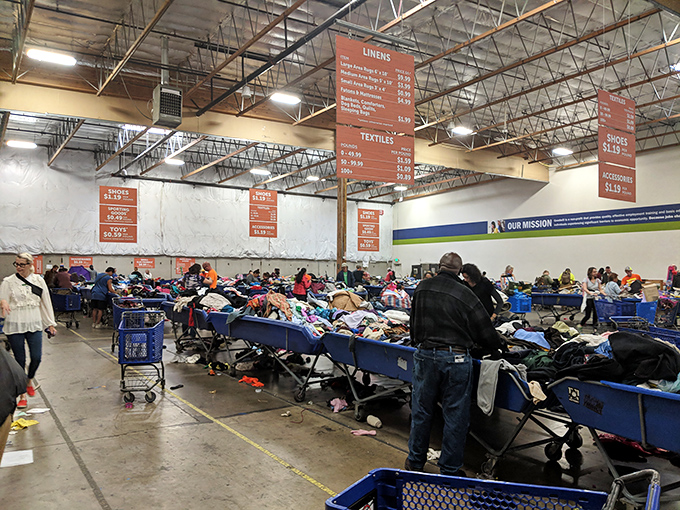 Organized chaos under industrial lighting&mdash;the thrifter's arena where patience and sharp eyes are rewarded with unexpected finds.