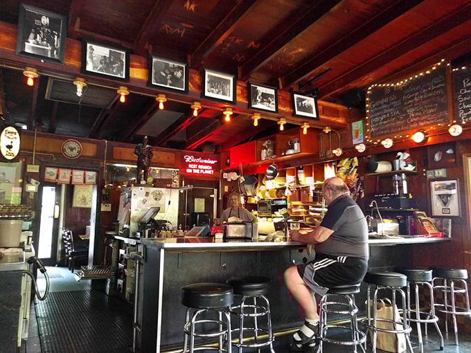Warm wood, vintage photographs, and the gentle glow of pendant lights create the kind of atmosphere that makes you want to linger over one more beer.