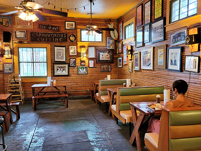 The "Carnivorous Cuisine" sign speaks the absolute truth in a wood-paneled dining room where barbecue dreams come true daily.
