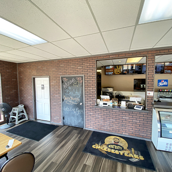 The welcoming counter area with that chalkboard message makes it clear: this is a place that values its customers as much as its cheesesteaks.