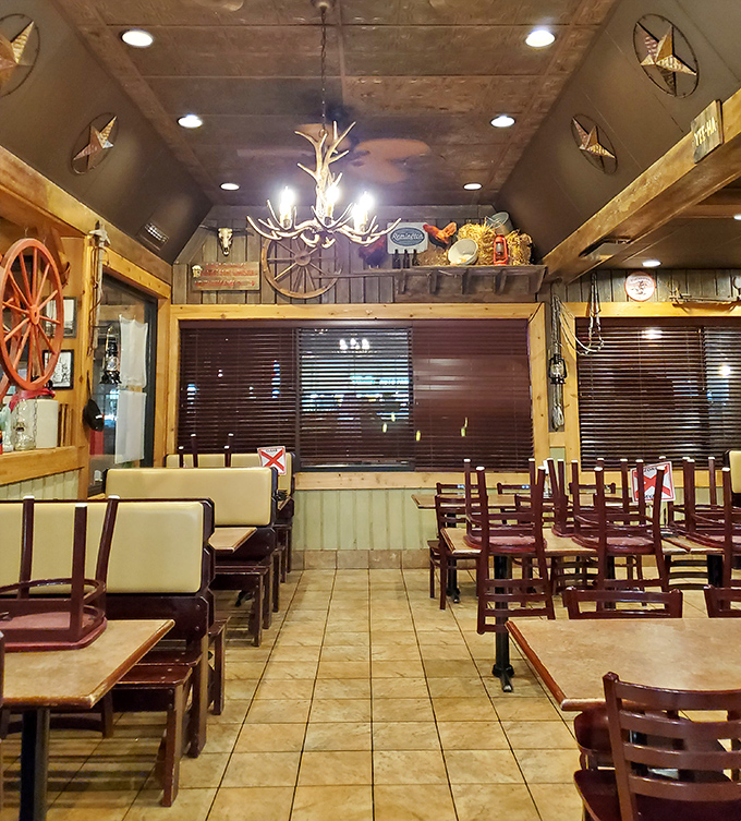 Rustic charm meets practical comfort in this dining space. That antler chandelier isn't trying to be hipster—it was country when country wasn't cool.