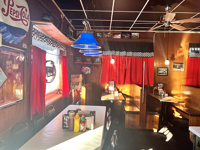 Red curtains frame wooden booths like theater boxes, setting the stage for the daily performance of American diner culture.