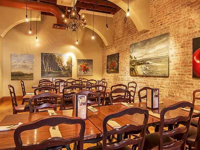 Exposed brick walls adorned with local artwork create dining rooms that feel both sophisticated and comfortably unpretentious.