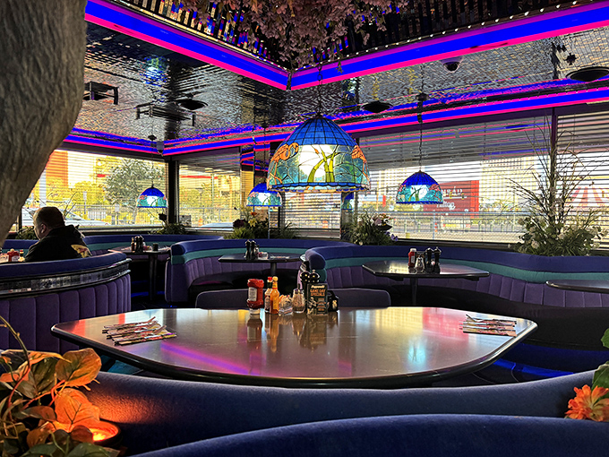 Curved booths cradle conversations while stained-glass lamps hang like jewels from the ceiling. This isn't just dining; it's a Vegas production.