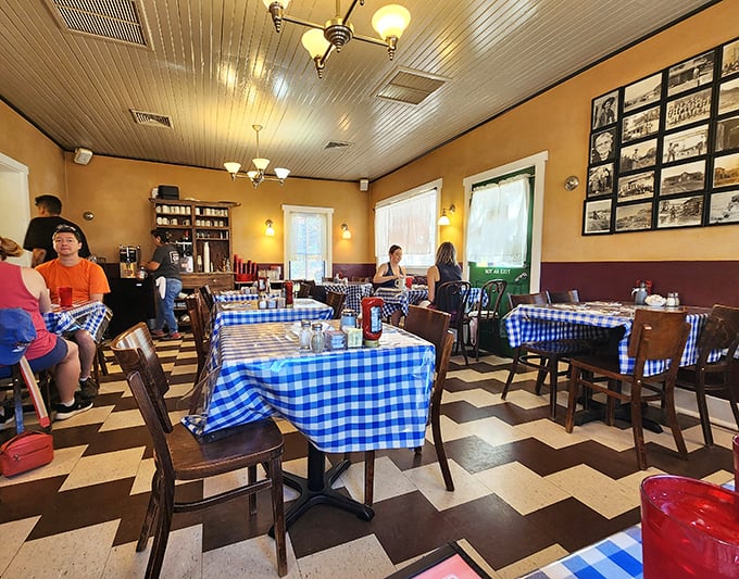 The checkerboard floor and historic photos create a breakfast diner time capsule&mdash;where nostalgia is served alongside fresh coffee.