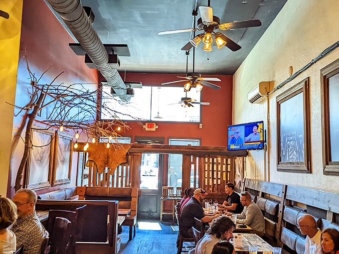 High ceilings and warm woods create not just a dining space, but a sanctuary where comfort food prayers are answered daily.