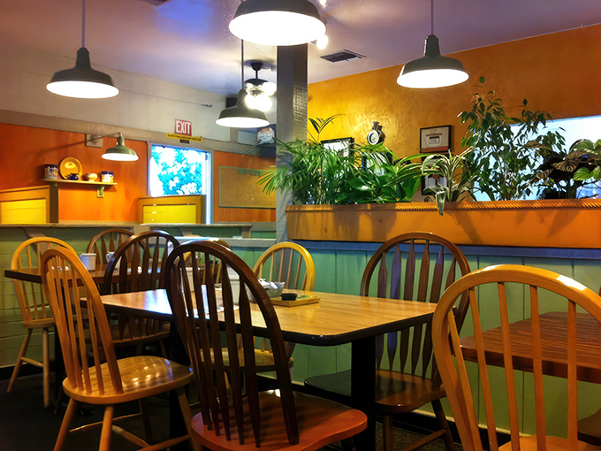 The warm orange walls and hanging plants create an atmosphere that feels like breakfast at a friend's house&mdash;if your friend happened to be an amazing cook.