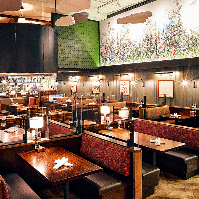 Thoughtful design elements like floral murals and green accents bring the farm ethos indoors. Dining booths that invite you to stay awhile.