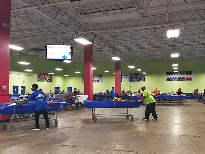 Workers orchestrate the blue bin ballet—a choreographed routine that brings fresh possibilities to eager treasure hunters every hour.