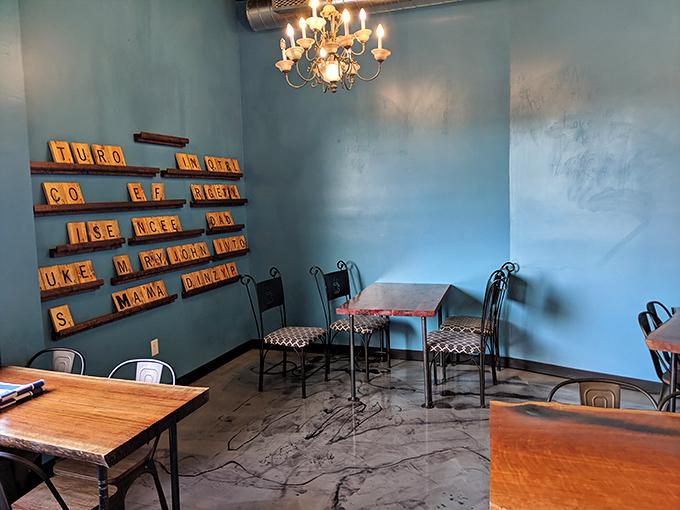 Scrabble tiles on the wall spell out playful messages while chandeliers cast a golden glow. It's like your coolest friend designed a donut shop.