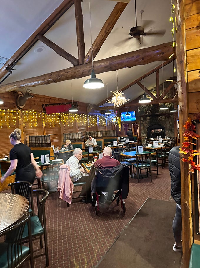 Exposed wooden beams and string lights create a warm, rustic atmosphere where generations of diners gather for meals worth remembering.