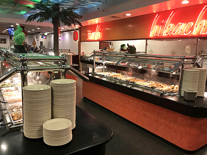 Plates stacked like a ceramic Tower of Pisa, patiently waiting their turn to support ambitious food architecture.