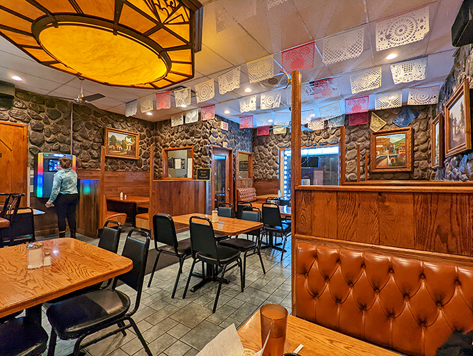 The warm glow of pendant lighting illuminates stone walls and colorful decorations, creating an atmosphere that feels both festive and comfortably familiar.