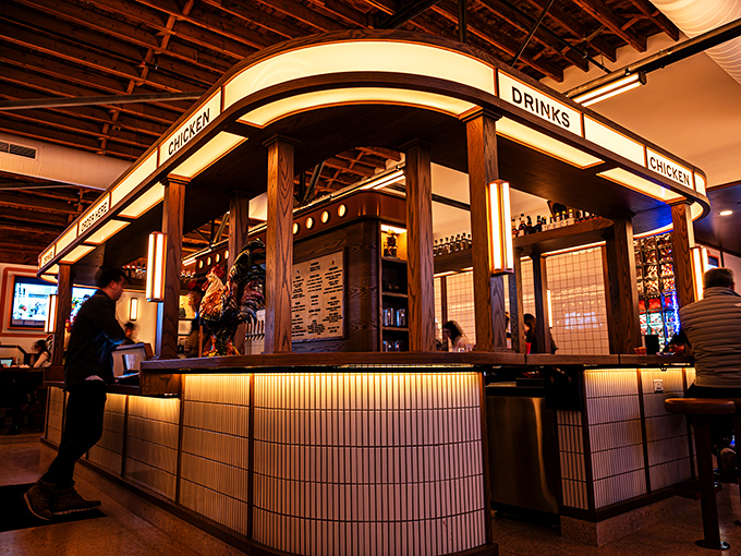 Evening transforms the interior into a warm haven of chicken worship. The illuminated counter beckons like a runway for your taste buds.