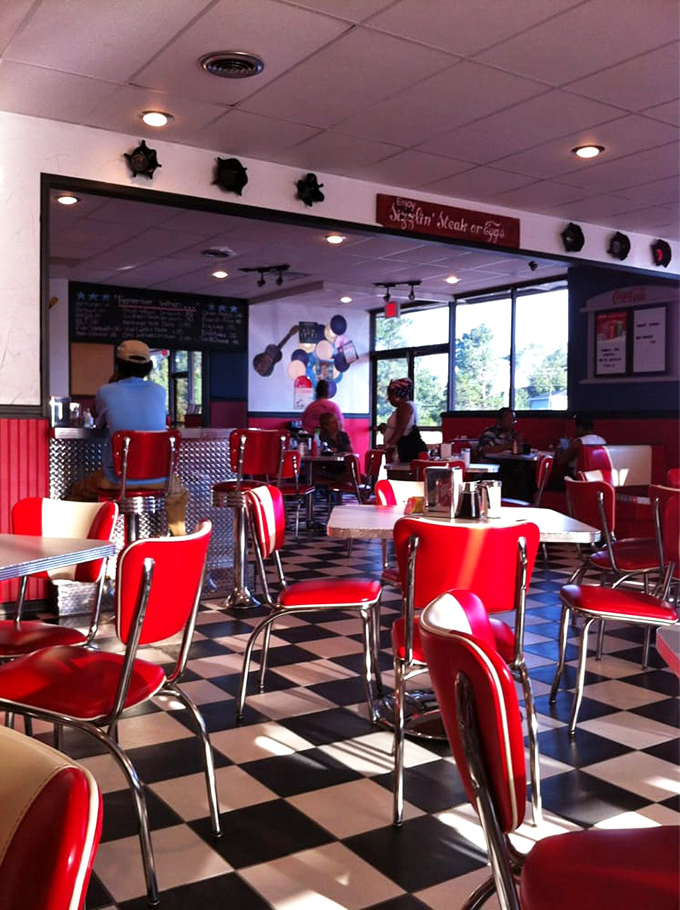 Red chairs invite you to stay awhile in this sunlit sanctuary of sizzling satisfaction and neighborly chatter.