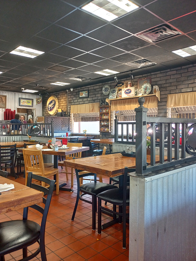 Wooden tables, simple chairs, and dividers creating cozy dining nooks &ndash; proof that great food doesn't need fancy surroundings to shine.