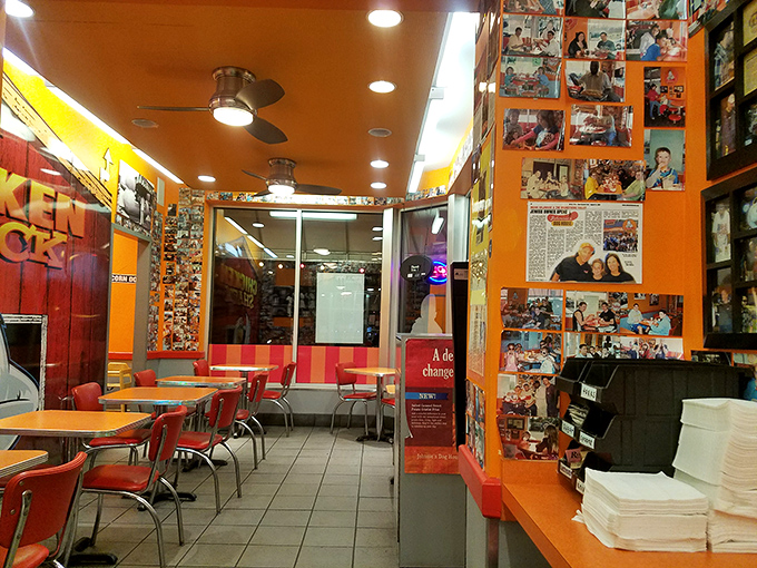 Customer photos line the vibrant orange walls &ndash; a hall of fame celebrating those who've accepted the delicious challenge.