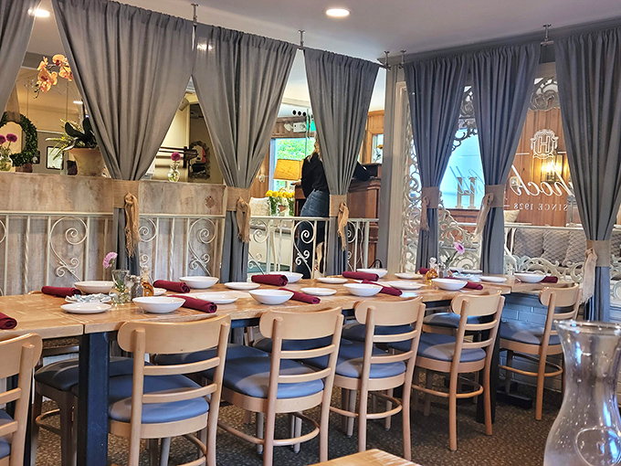 Blue curtains frame this dining space like a stage where the real stars are the plates of food that will soon make their grand entrance.