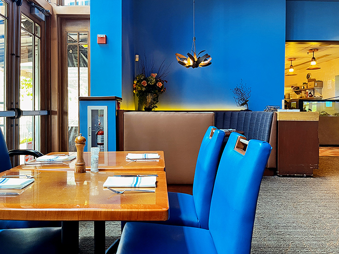 Bold blue walls and warm wood create dining spaces that feel both intimate and social&mdash;like your favorite dinner party without having to do dishes.