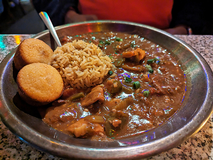Rich, dark roux forms the foundation of this hearty jambalaya. Served with rice and cornbread, it's comfort food with a Cajun kick.