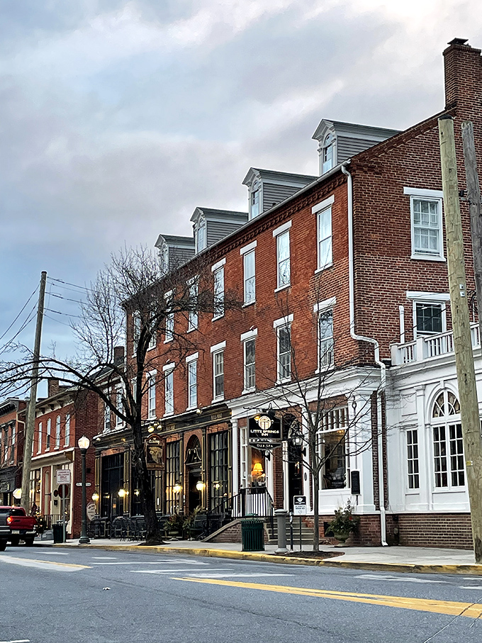 These historic brick buildings with their perfectly preserved storefronts make you feel like you've wandered onto a movie set where everyone's just exceptionally good at acting normal.