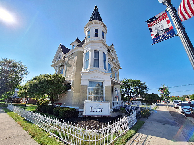 The Eley Funeral Home's Victorian splendor showcases the architectural ambition of another era, its turret and wraparound porch exuding quiet dignity.