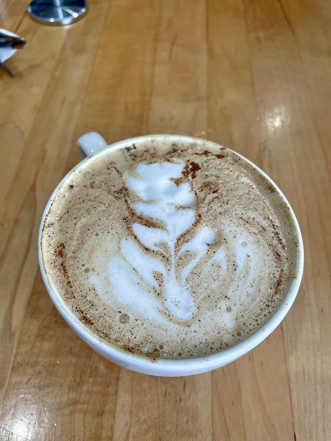 The latte art is so pretty you almost don't want to drink it—almost. That leaf design is practically begging for an Instagram moment.