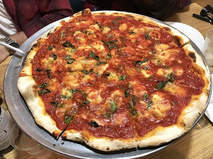A classic red pie with that signature char around the edges. The crust bubble geography tells you everything about proper oven management.
