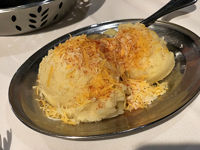 Mashed potatoes with a golden cheese crown—the comfort food equivalent of a warm hug from your grandmother who secretly knows how to party.
