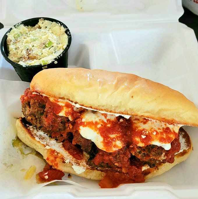 This isn't just a meatball sub; it's a saucy, cheesy commitment that requires both hands and possibly a nap afterward.