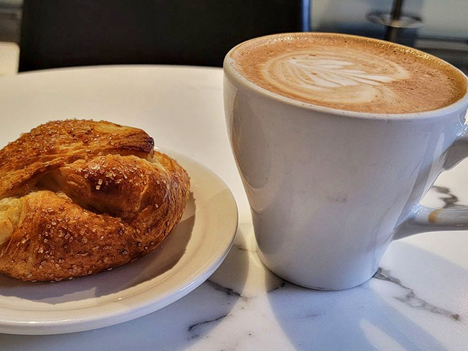The perfect morning duet: a cinnamon-kissed danish alongside a latte with foam art worthy of gallery display. Breakfast ascends to art form.