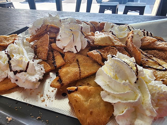 These cinnamon-sugar sopapilla chips with whipped cream aren't just dessert; they're the sweet punctuation mark at the end of a perfect meal.