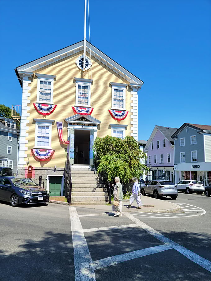 Marblehead's 1727 Old Town House stands proudly decorated in patriotic bunting, a yellow sentinel that has witnessed nearly three centuries of American history.