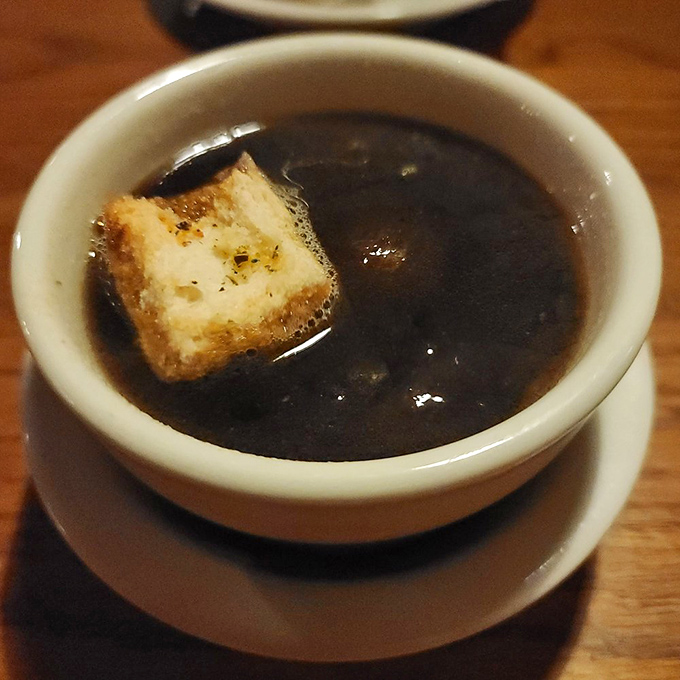 This isn't just onion soup&mdash;it's a dark, mysterious pool where a brave crouton floats, sacrificing itself for your flavor journey.