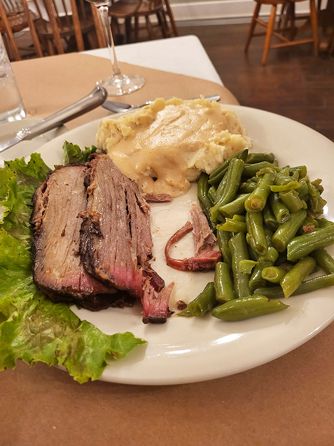 Open-faced hot beef served with zero pretension and maximum flavor&mdash;tender slices over mashed potatoes swimming in savory gravy.