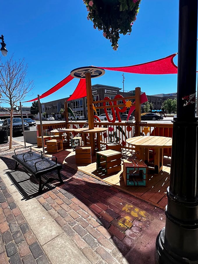Outdoor seating where Kansas sunshine becomes an ingredient in your meal, with red awnings providing just enough shade for perfect people-watching conditions.