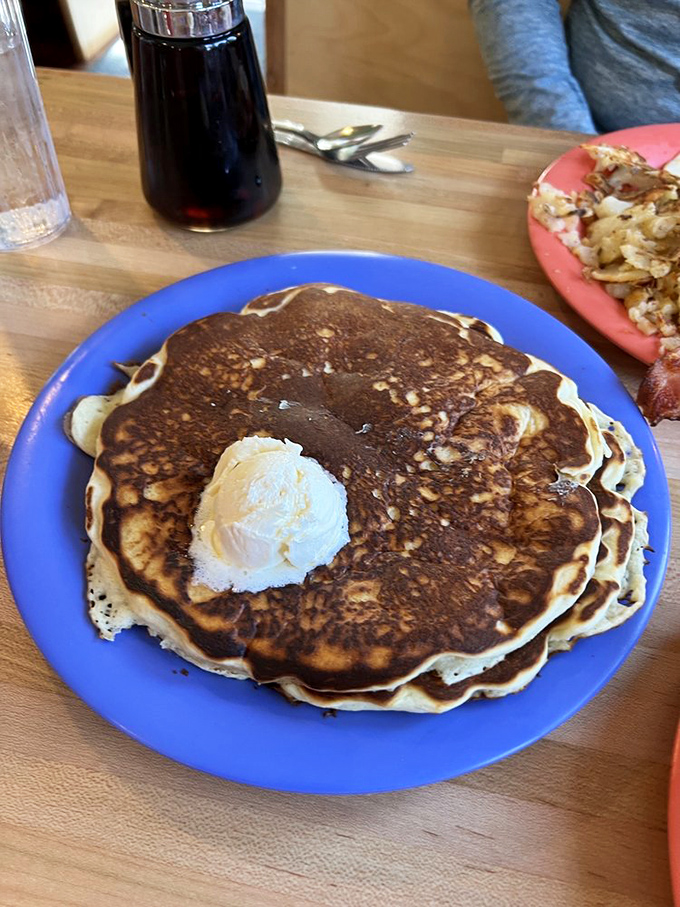 These pancakes aren't just round&mdash;they're perfectly circular flavor discs with a melting pat of butter that's basically performing a swan dive into breakfast heaven.