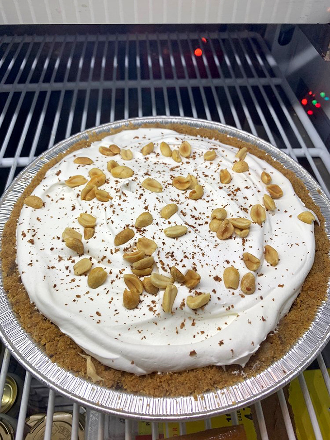 Peanut butter pie topped with roasted peanuts &ndash; because after conquering mountains of smoked meat, you deserve this creamy reward.