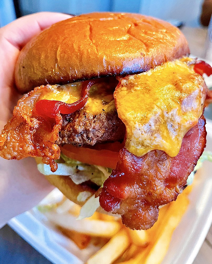 This isn't just a burger; it's an engineering marvel of bacon, cheese, and beef. The kind of sandwich that requires both hands and zero distractions.