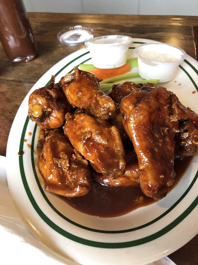 Wings swimming in sauce that demands to be licked from fingers &ndash; no fancy wipes needed, just pure messy pleasure.